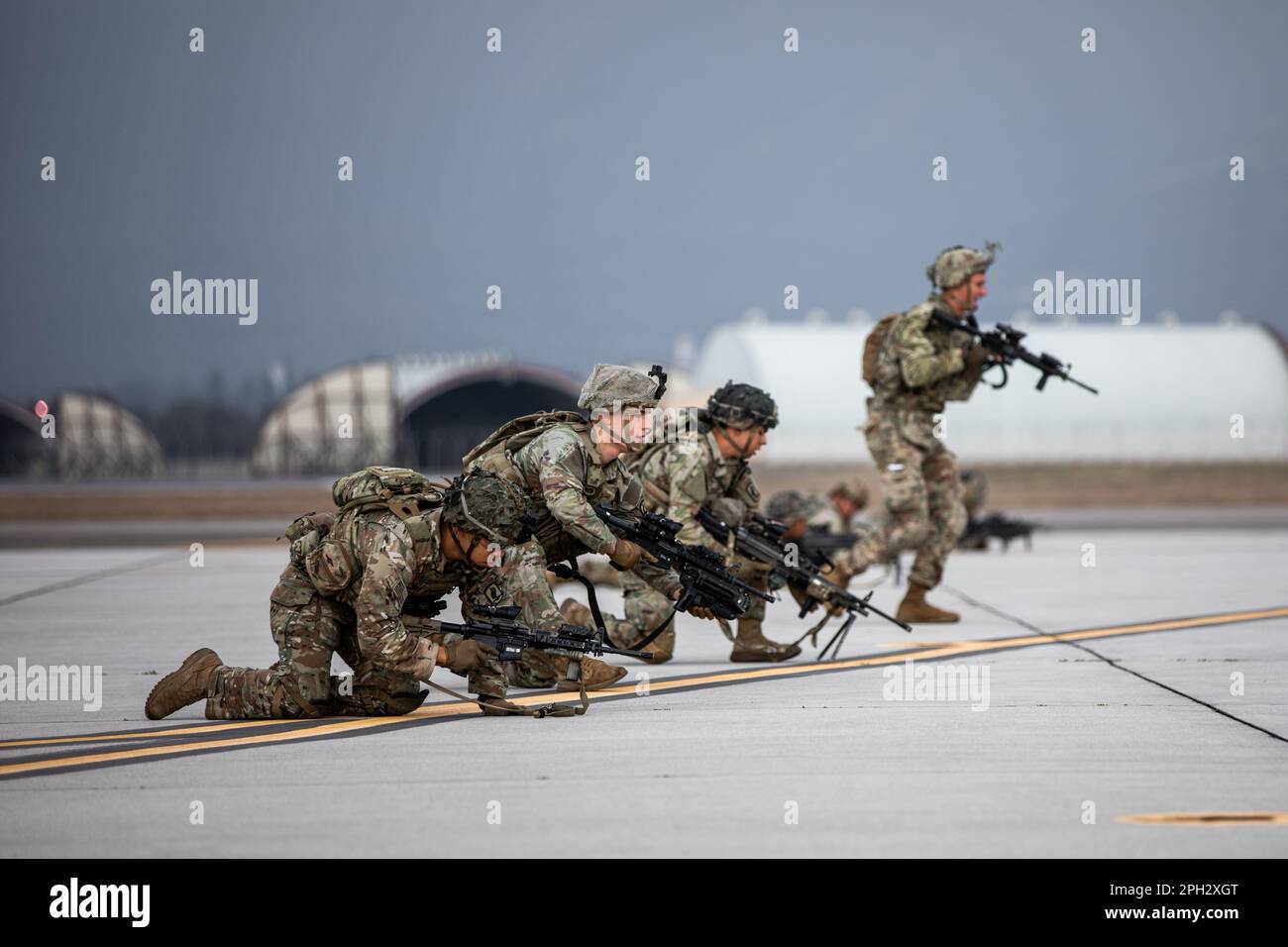 U.S Army Soldiers from the 173rd Airborne Brigade walk through securing ...