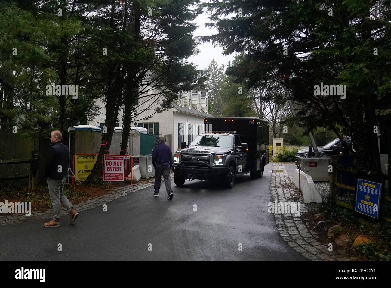 Security personnel walk on a driveway leading to President Joe Biden's ...
