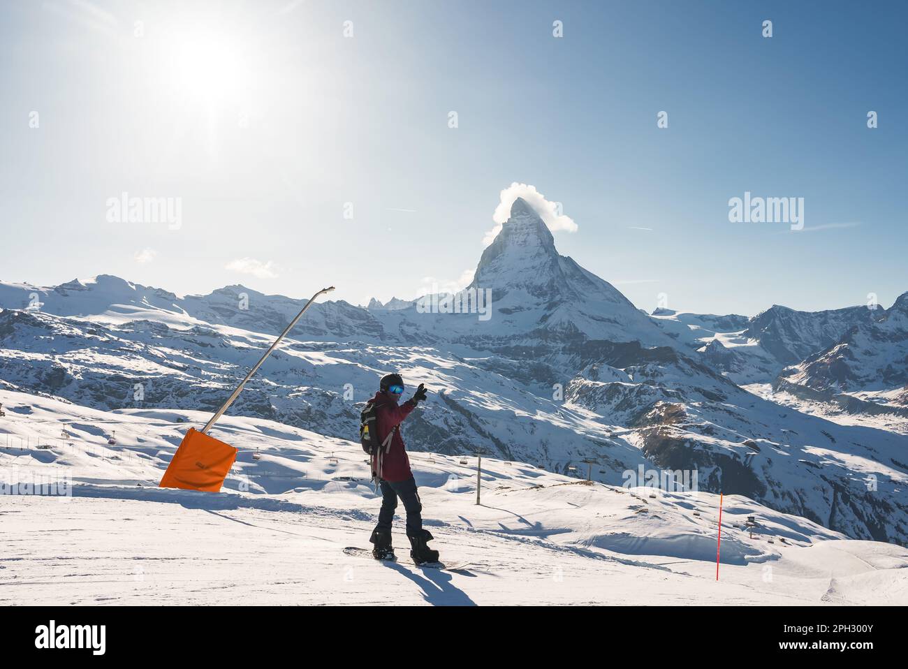 Young man snowboarding in Zermatt ski resort right next to the famous ...