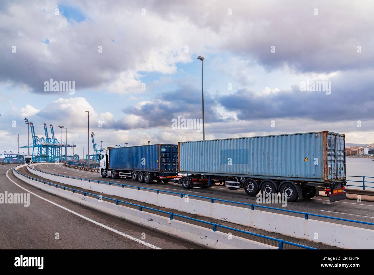 Duo trailer with containers circulating through the entrance bridge to ...