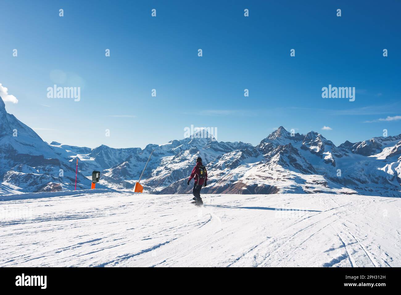 Young man snowboarding in Zermatt ski resort right next to the famous ...