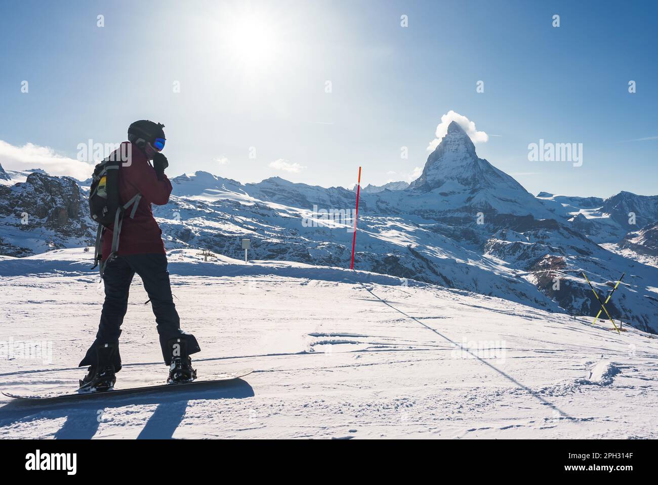 Young man snowboarding in Zermatt ski resort right next to the famous ...