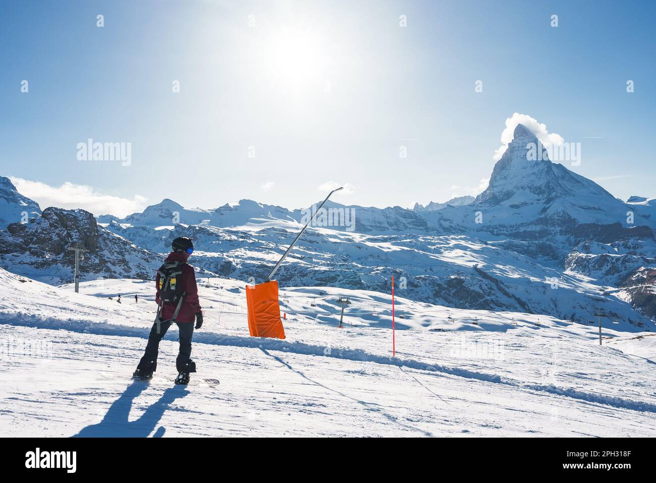 Young man snowboarding in Zermatt ski resort right next to the famous ...