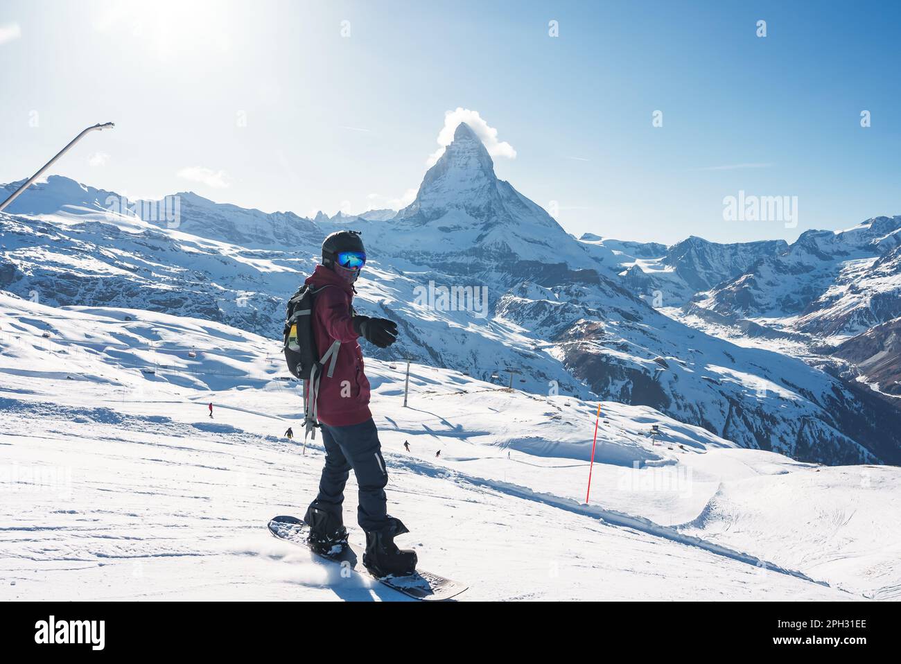 Young man snowboarding in Zermatt ski resort right next to the famous ...