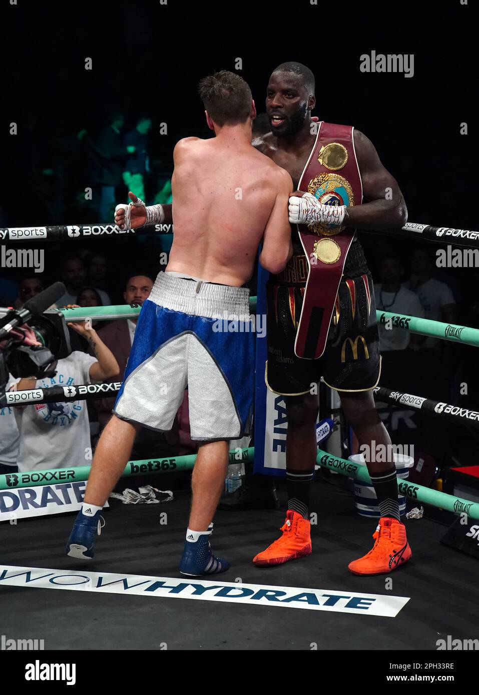 David Light (left) hugs Lawrence Okolie following the WBO World ...