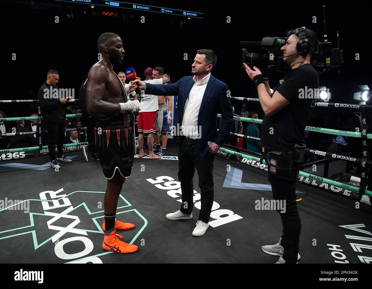 Lawrence Okolie (left) celebrates retaining the WBO World Cruiserweight ...