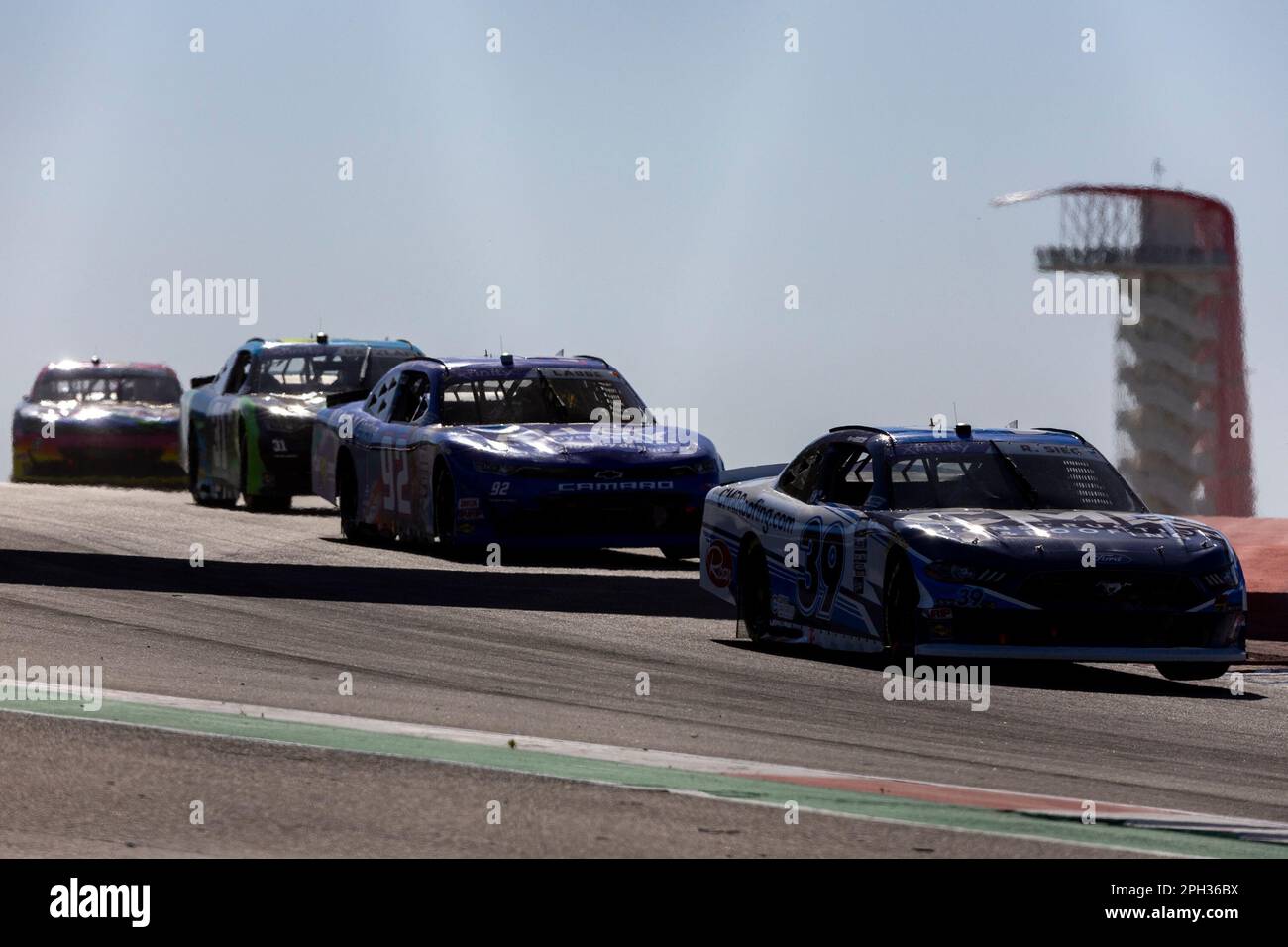 Parker Retzlaff (31), Alex Labbe (92) and Ryan Sieg steer their cars ...