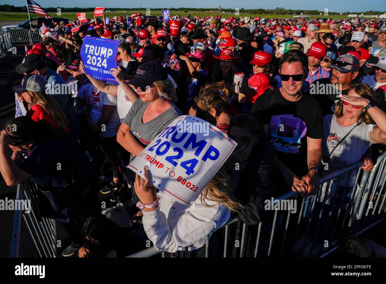 People listen as former President Donald Trump speaks at a campaign ...