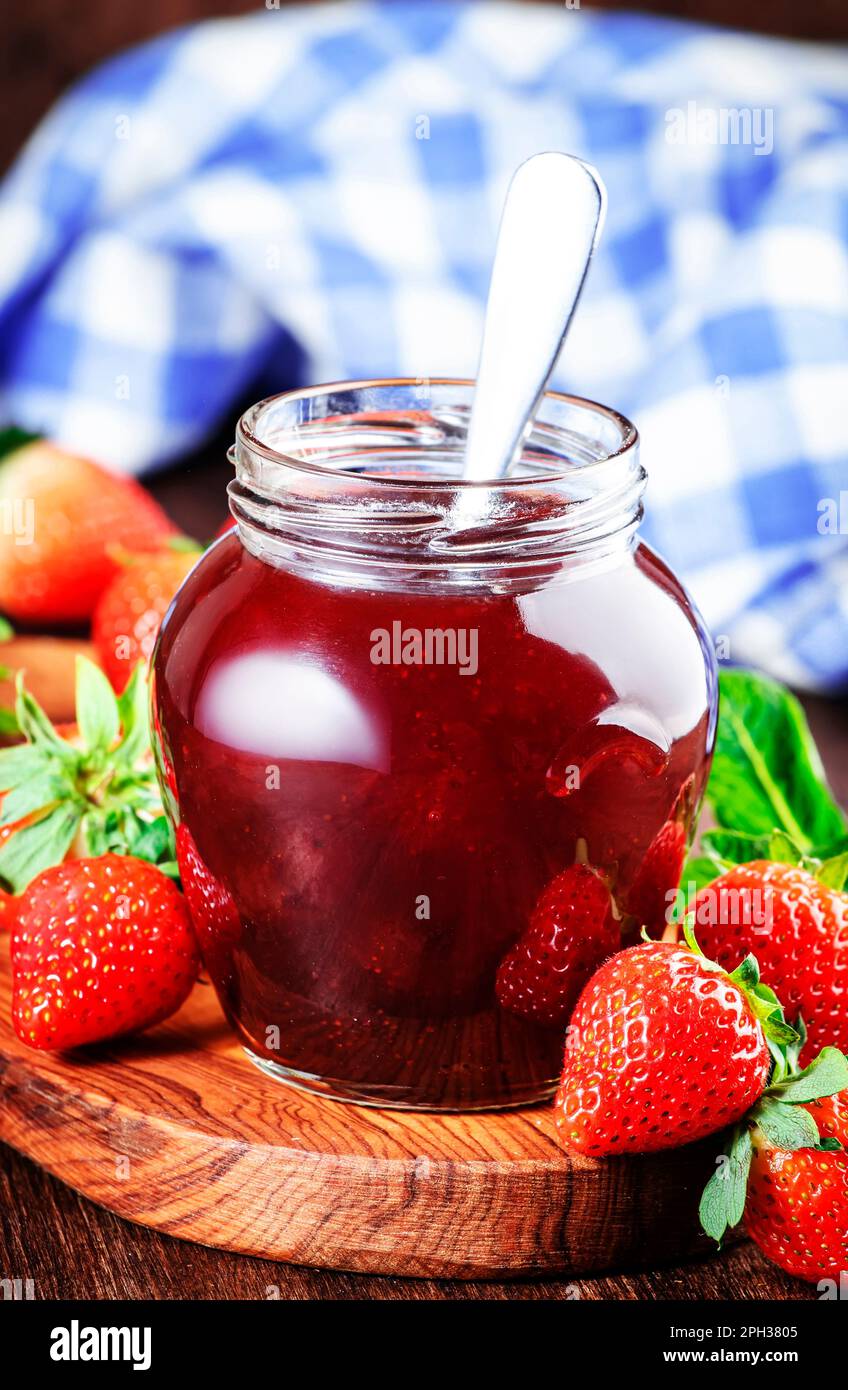 Strawberry jam in glass jar and fresh berries, rustic wooden table ...
