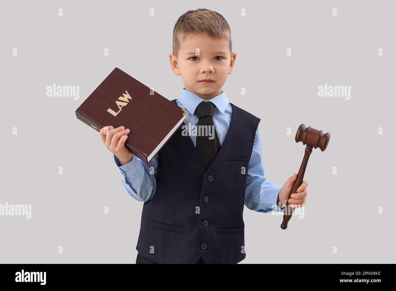 Cute little judge with law book and gavel on grey background Stock ...