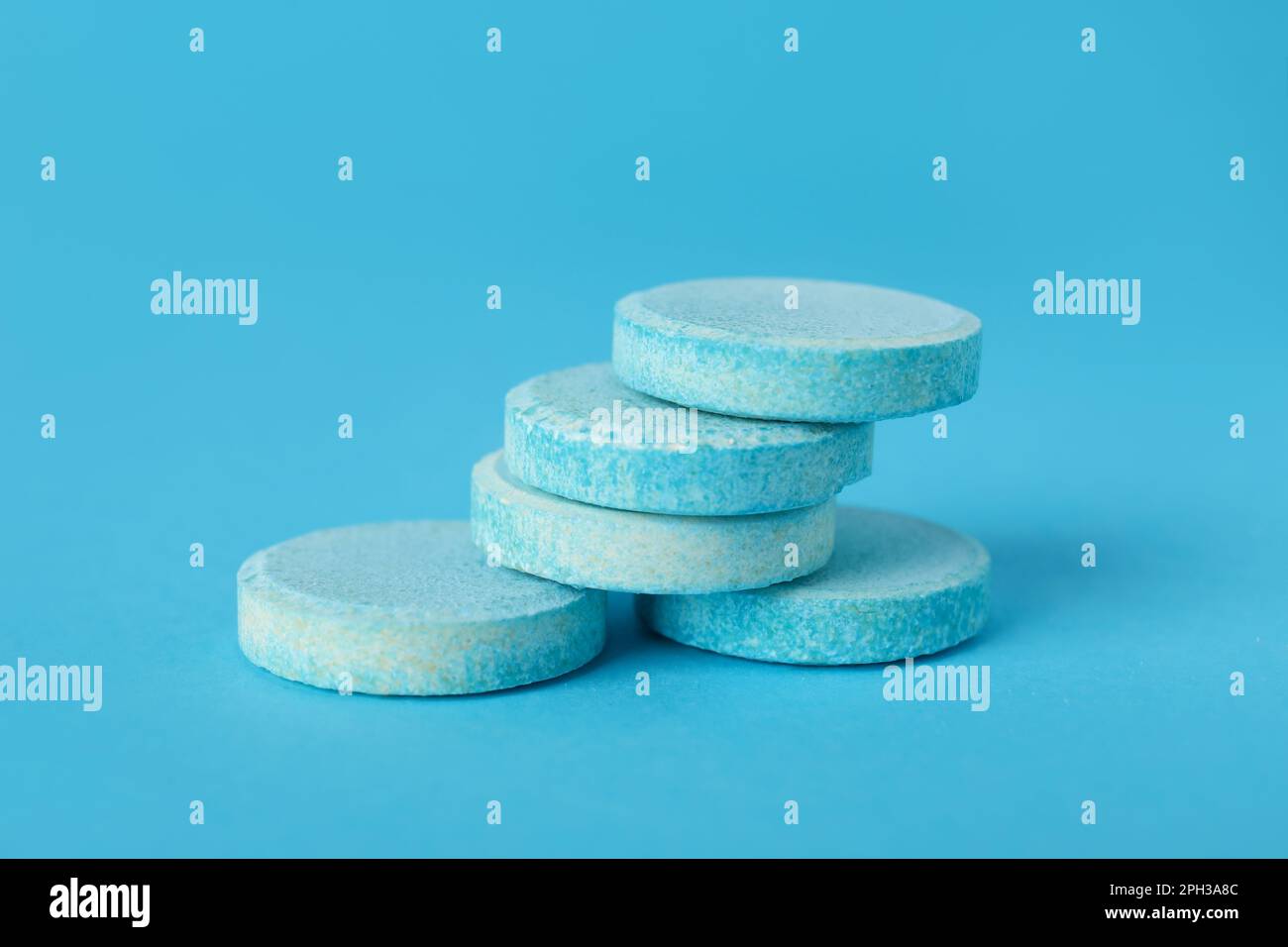 Soluble tablets on blue background Stock Photo - Alamy