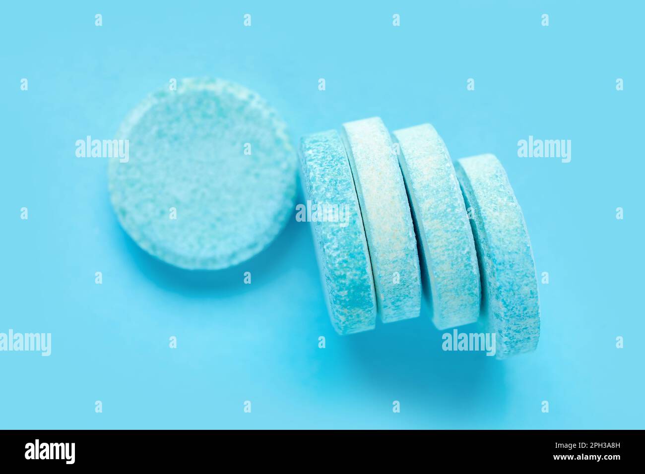 Soluble tablets on blue background Stock Photo - Alamy