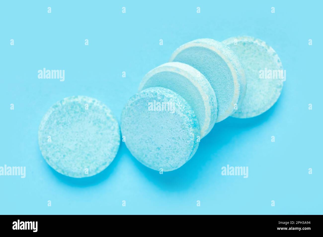 Soluble tablets on blue background Stock Photo - Alamy
