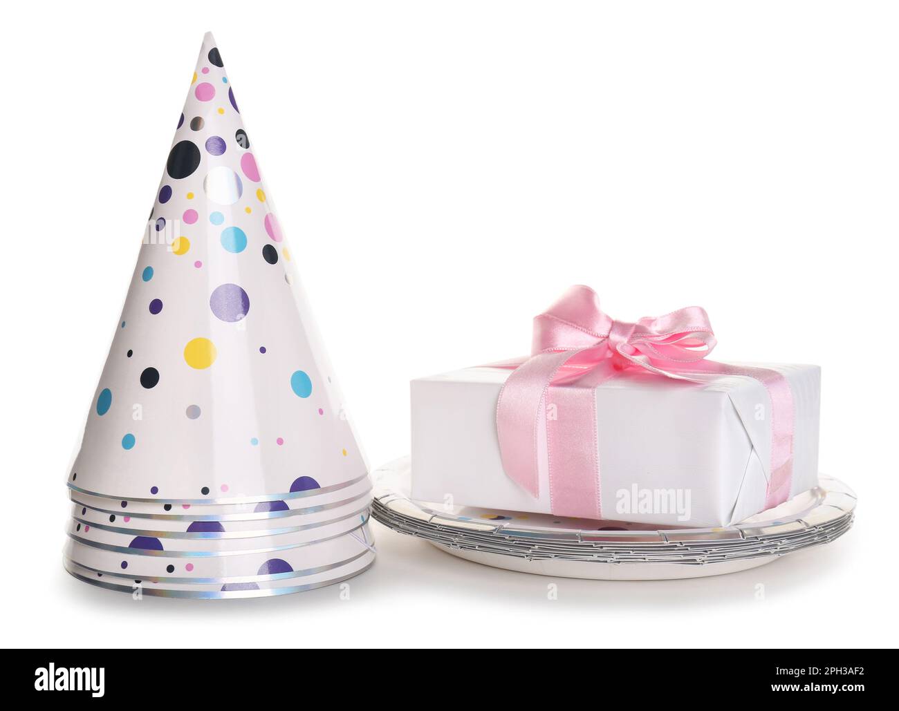 Party hats with gift box and plates on white background Stock Photo - Alamy