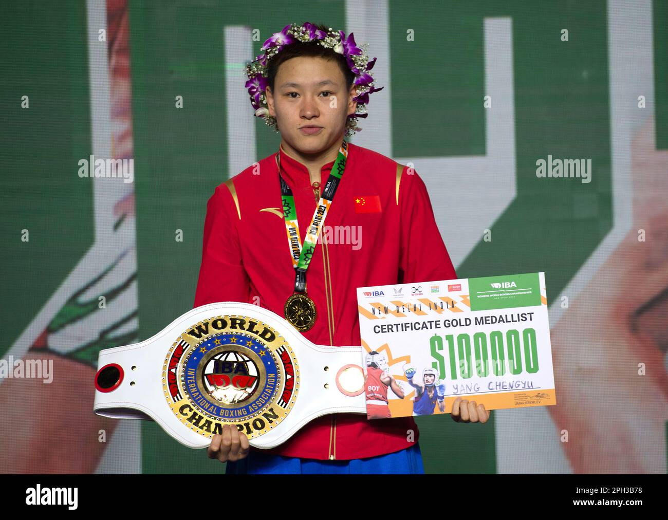 New Delhi, India. 25th Mar, 2023. Yang Chengyu (L) of China reacts during the medal ceremony ...