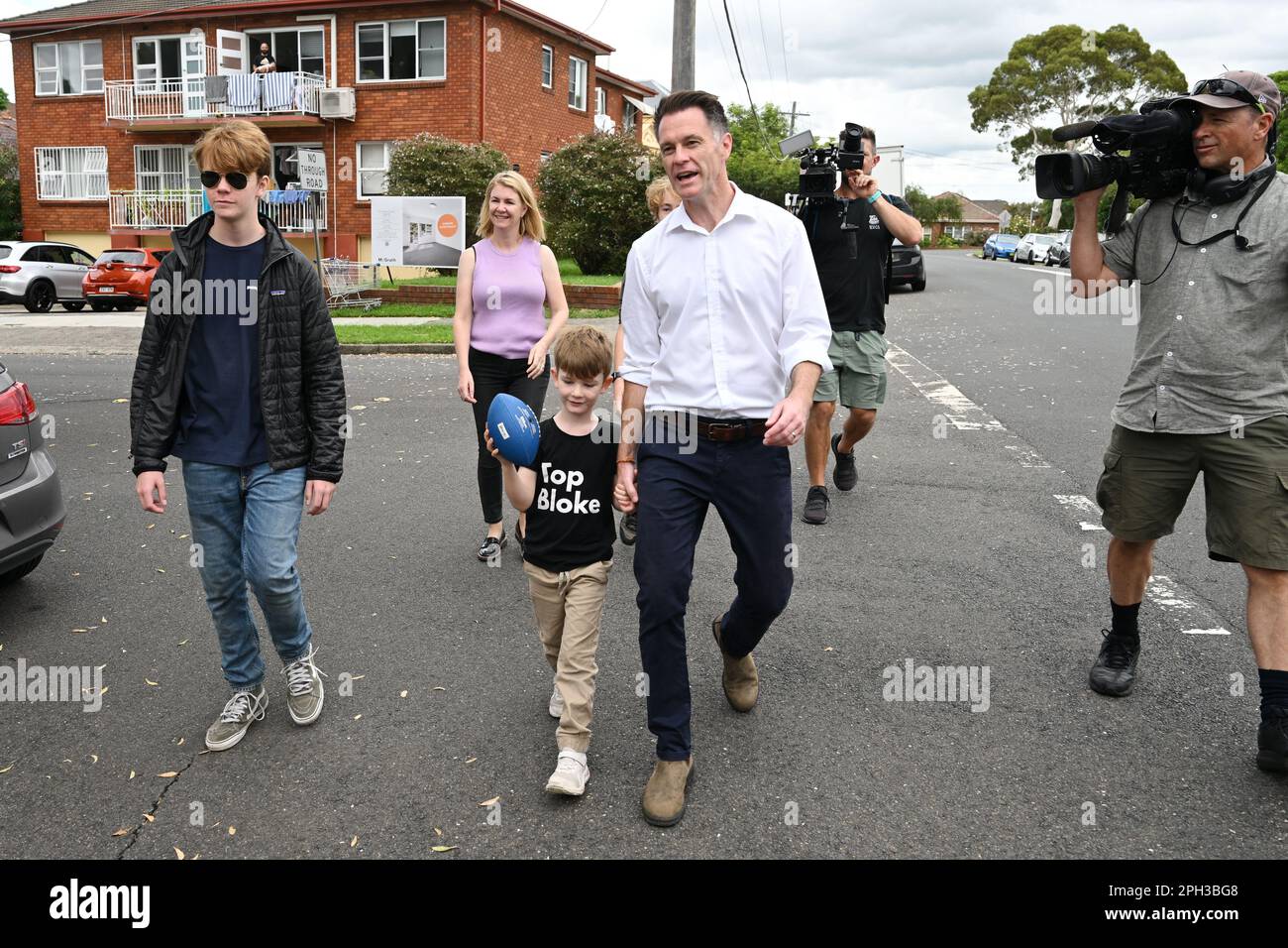 Incoming NSW Premier Chris Minns walks to a local cafe with his wife ...