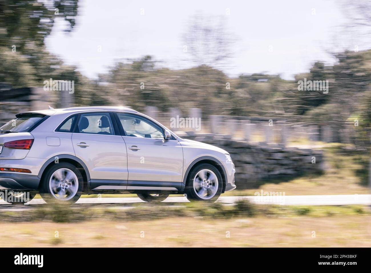 SUV style car in gray color, driving on the road at high speed during ...