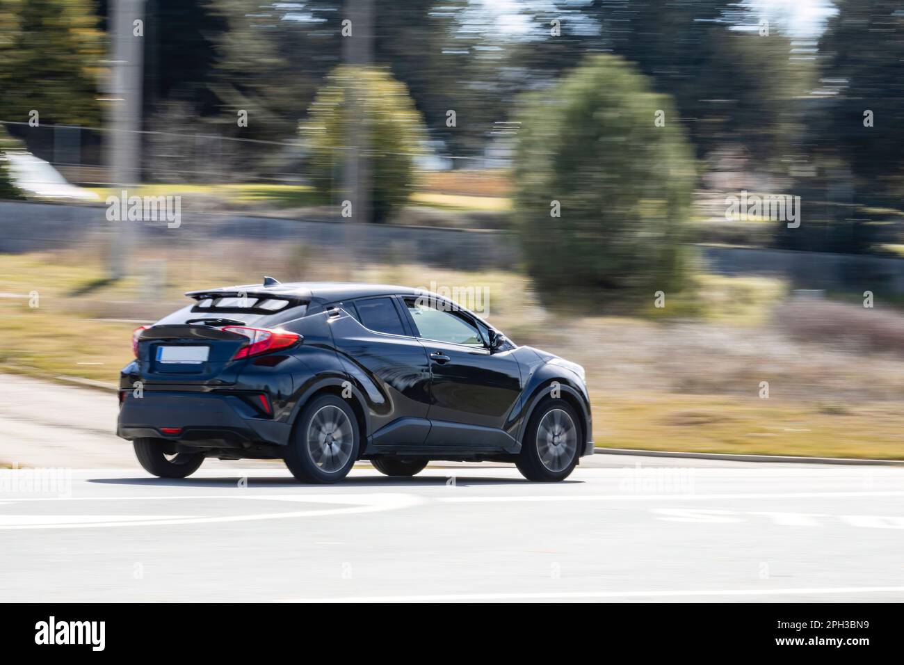 SUV style car in black color, driving on the road at high speed during ...