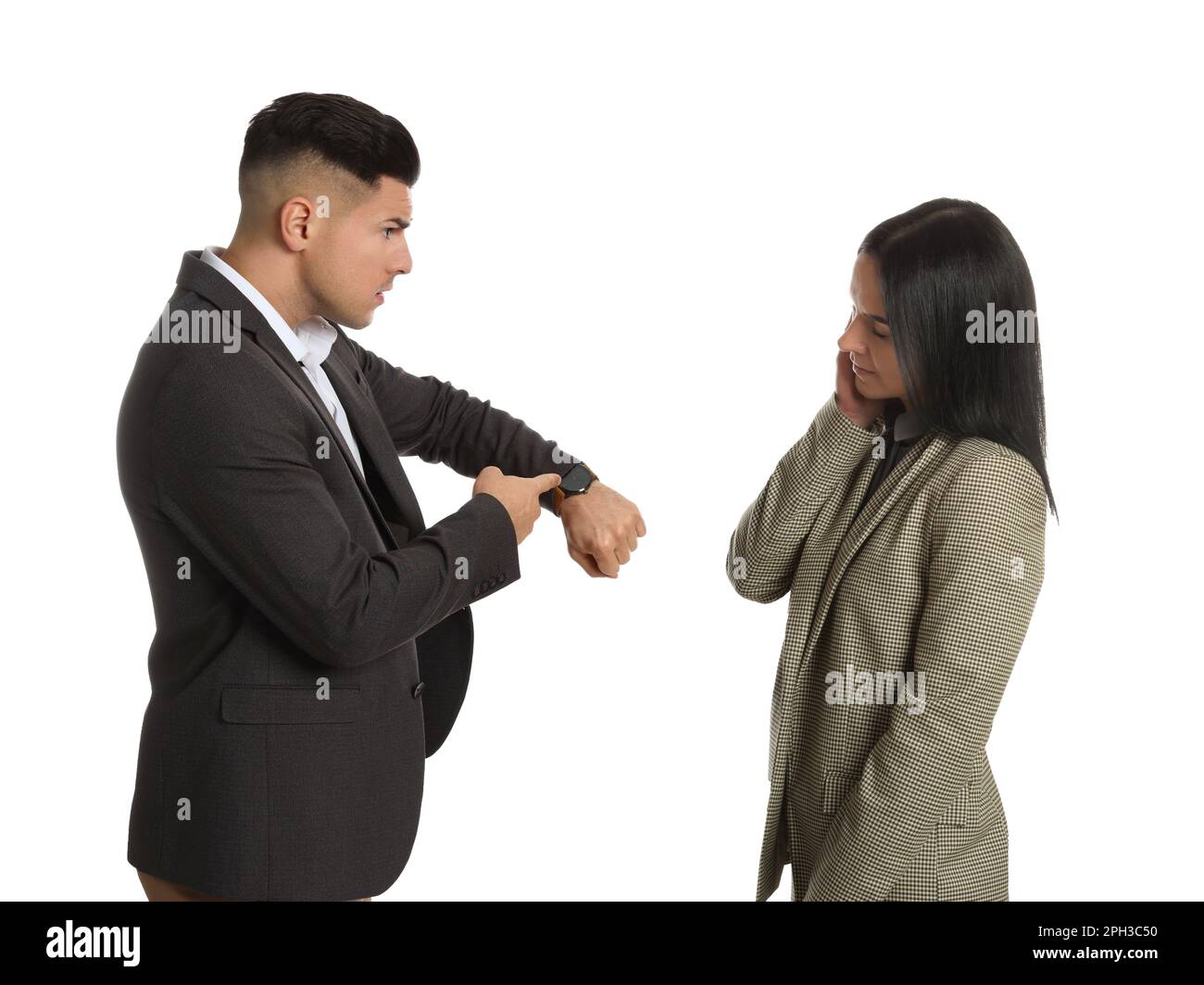 Businessman pointing on wrist watch while scolding employee for being ...