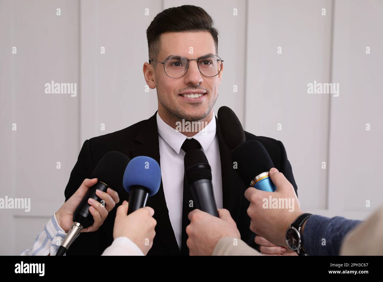 Happy business man giving interview to journalists at official event ...