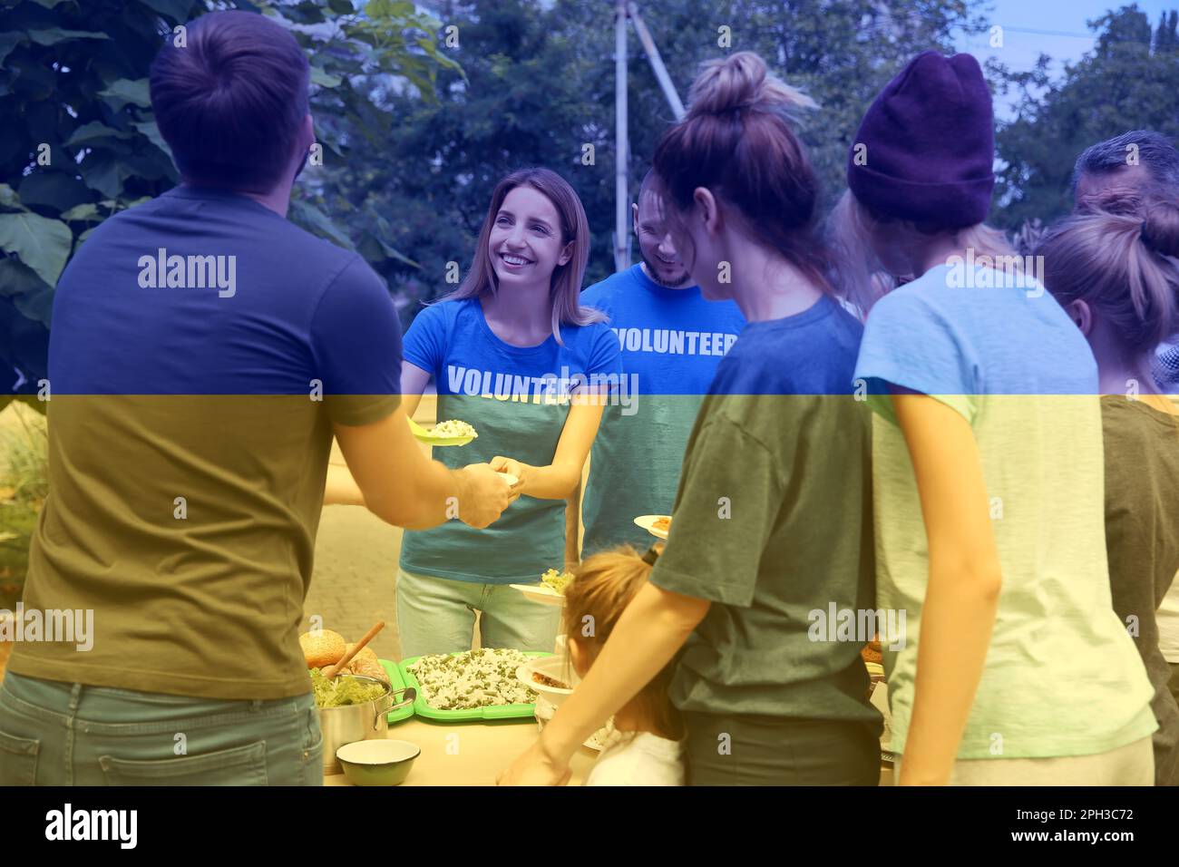 Double exposure of volunteers serving food to refugees and Ukrainian ...