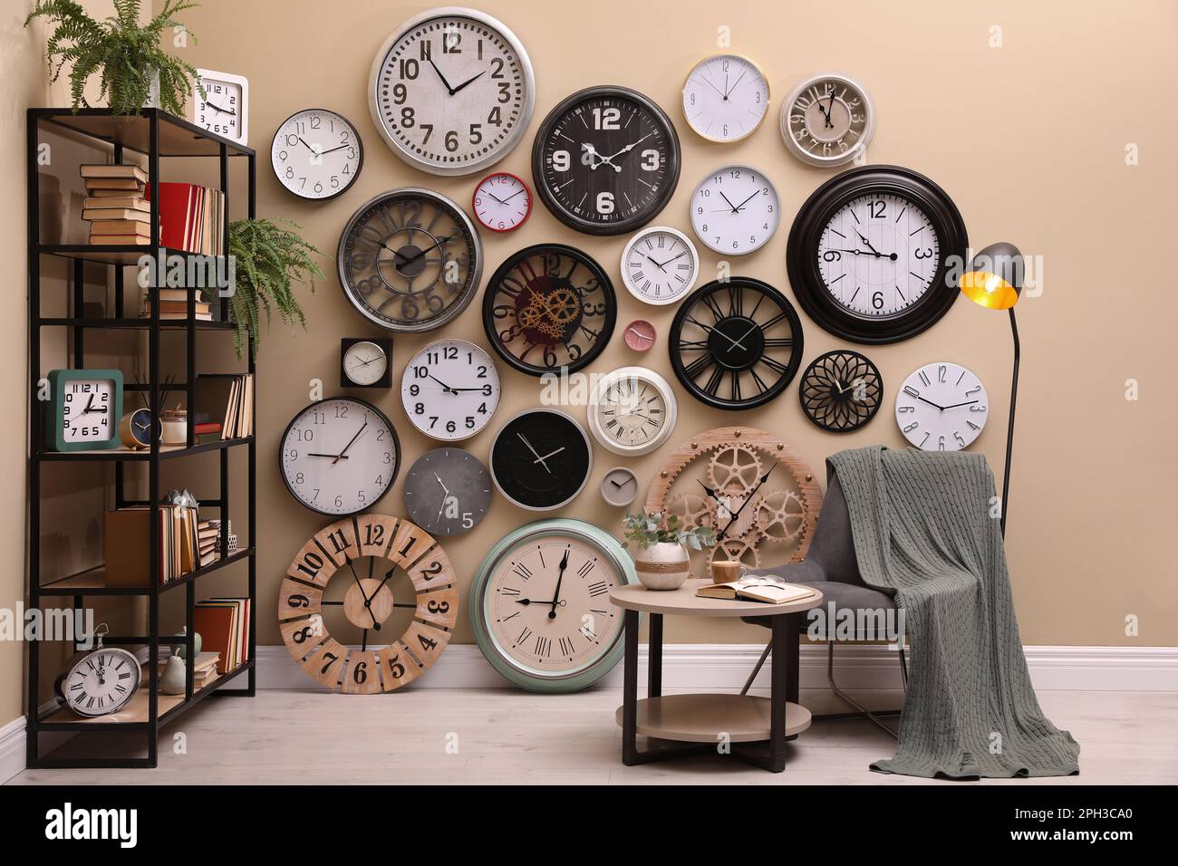 Stylish room interior with collection of wall clocks Stock Photo - Alamy