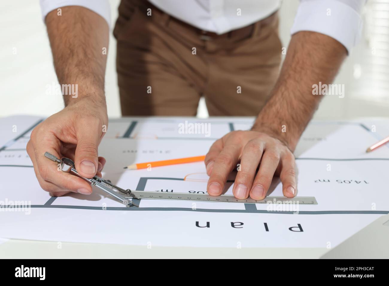 Architect working with construction drawings indoors, closeup Stock ...