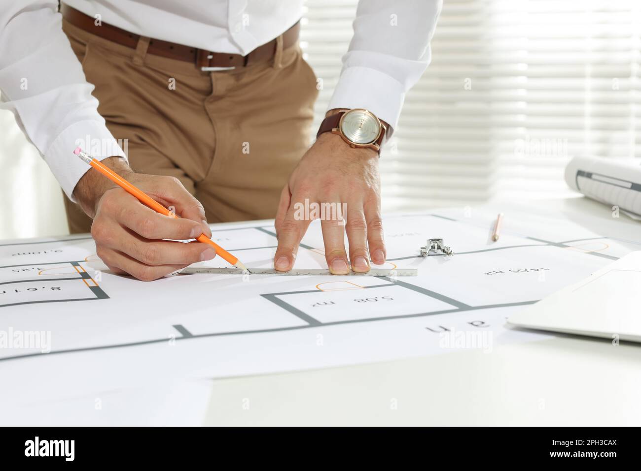 Architect working with construction drawings in office, closeup Stock Photo - Alamy