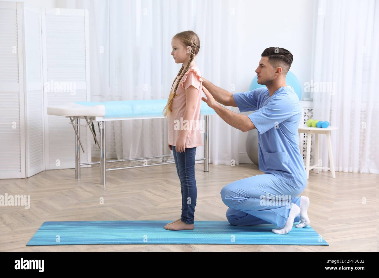 Orthopedist examining child's back in clinic. Scoliosis treatment Stock ...