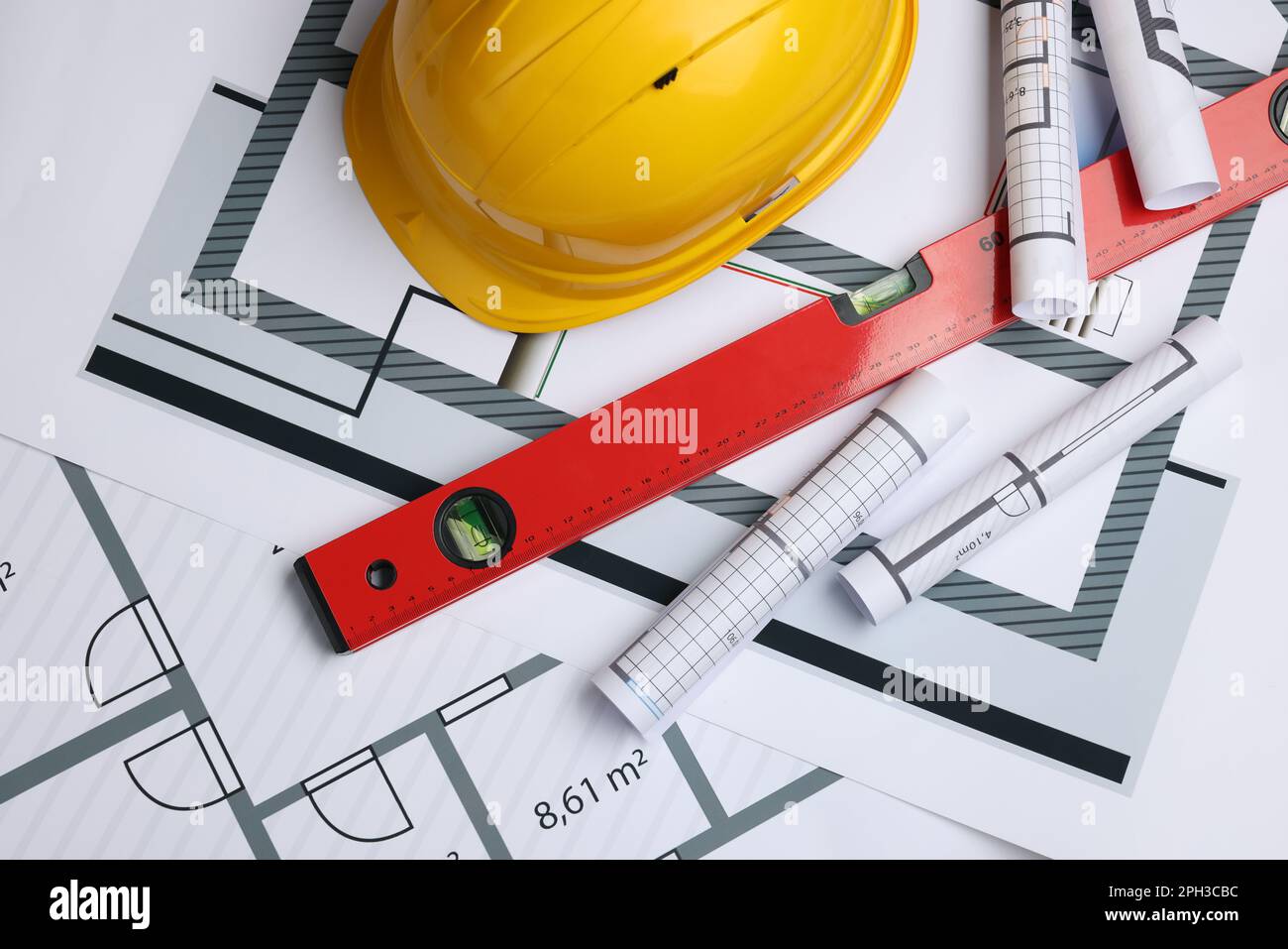 Construction drawings, safety hat and bubble level on house plan, flat ...