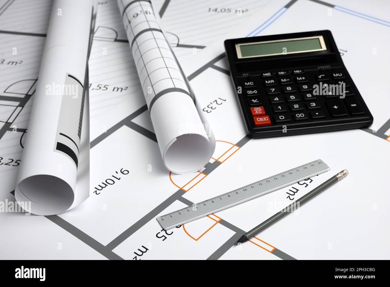 Construction drawings, ruler, pencil and calculator on house plan ...