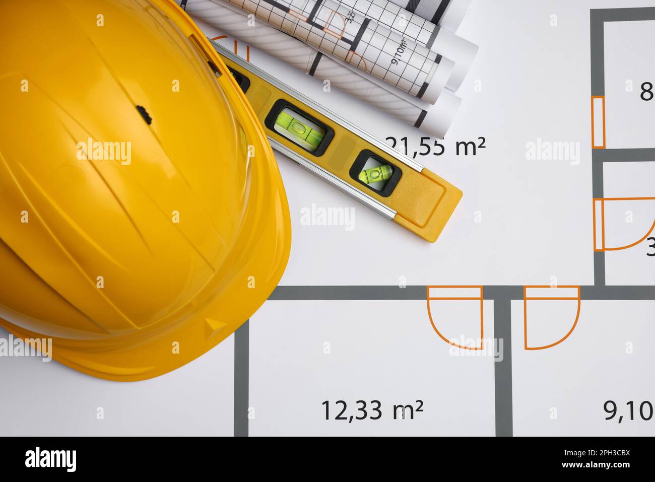 Construction drawings, safety hat and bubble level on house plan, flat ...