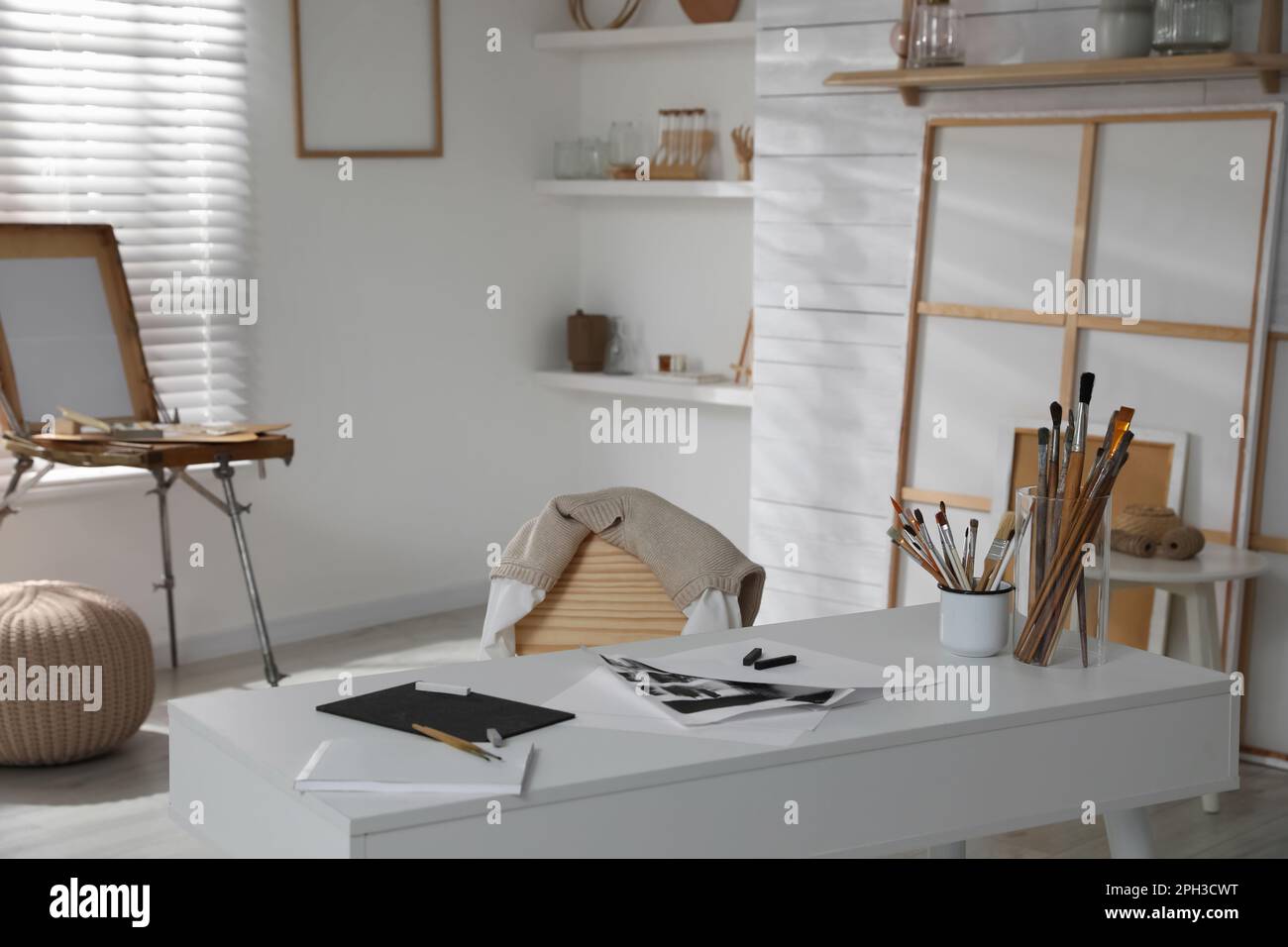 Modern studio interior with artist's workplace and wooden easel Stock ...