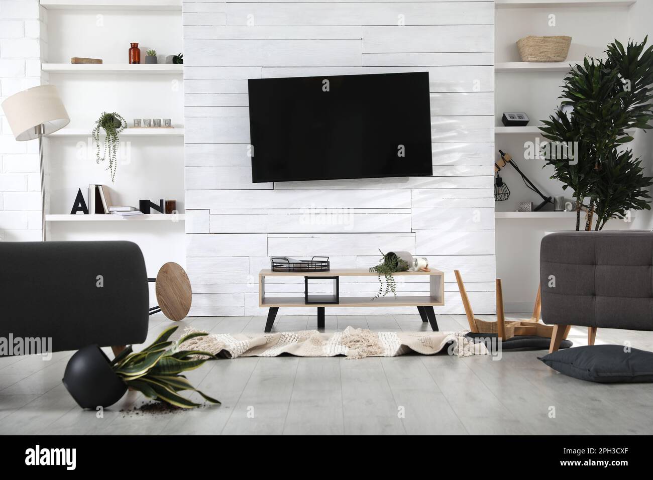 Chaotic living room interior after strong earthquake Stock Photo - Alamy