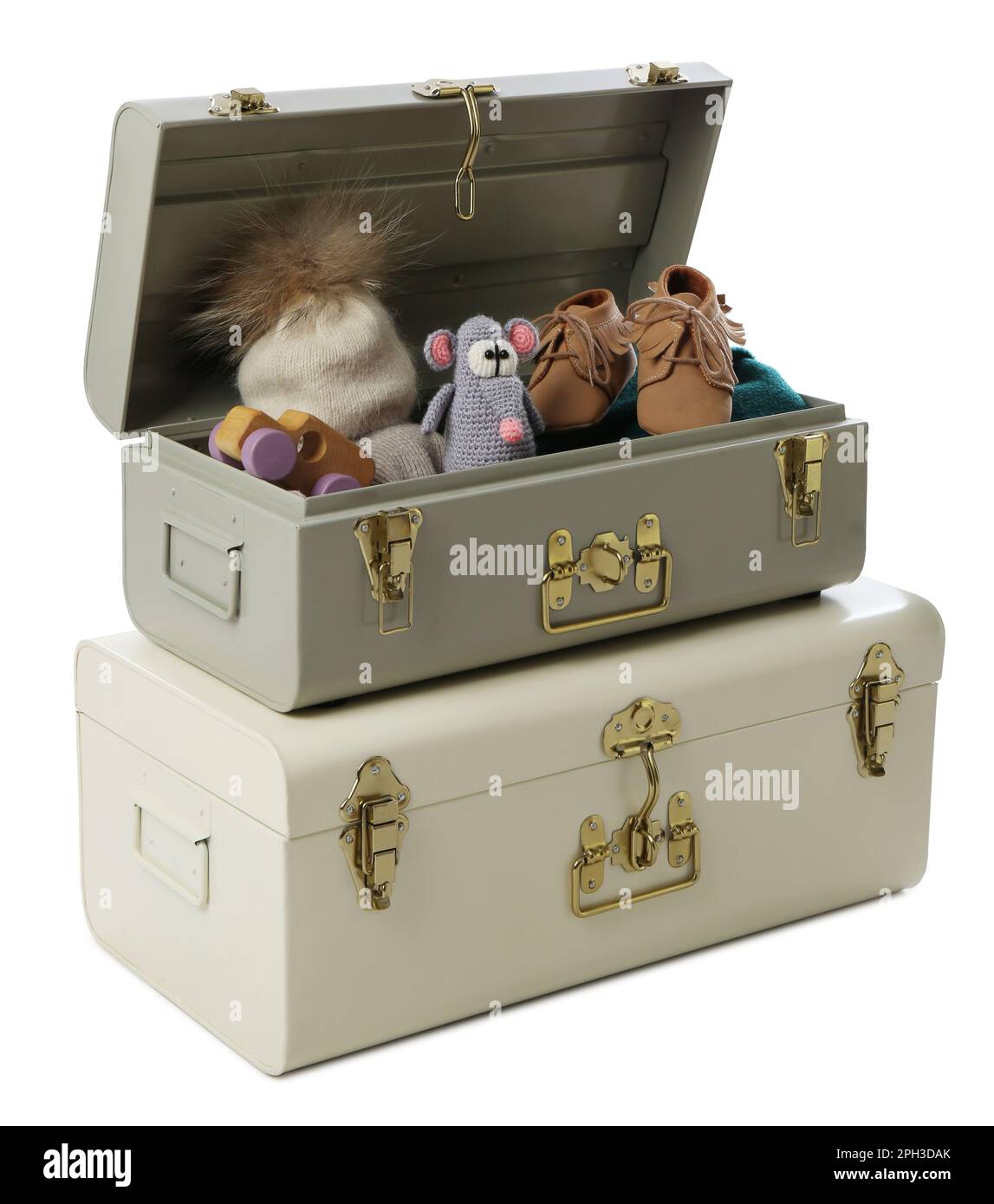 Stylish storage trunks with child's shoes and toys on white background ...