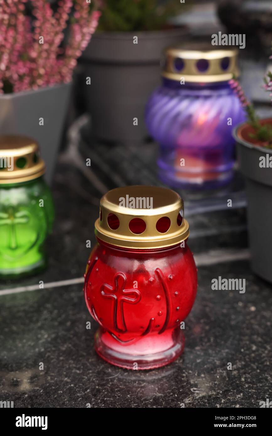 Different grave lanterns on granite surface at cemetery Stock Photo - Alamy