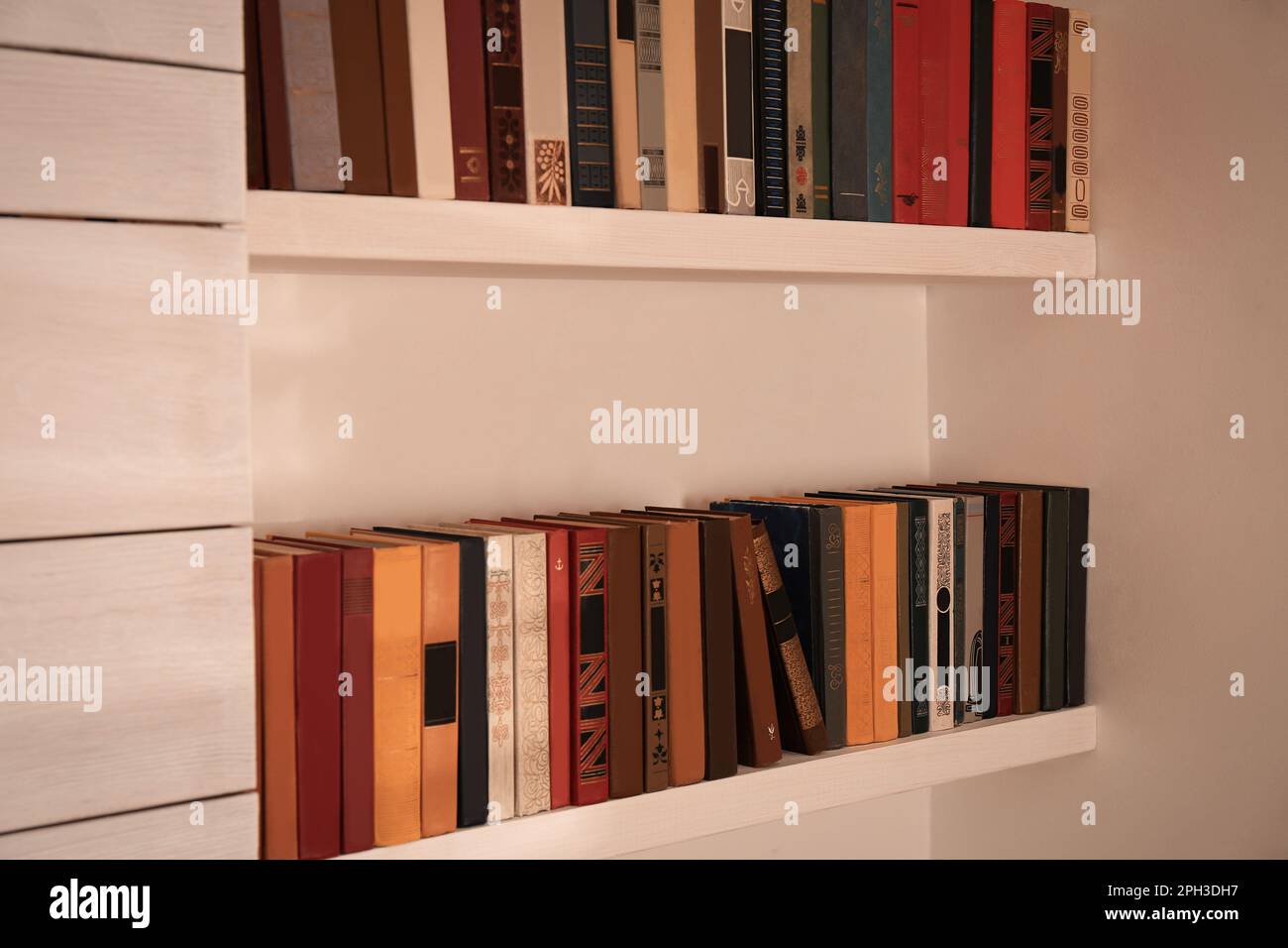 Collection of different books on shelves. Home library Stock Photo - Alamy