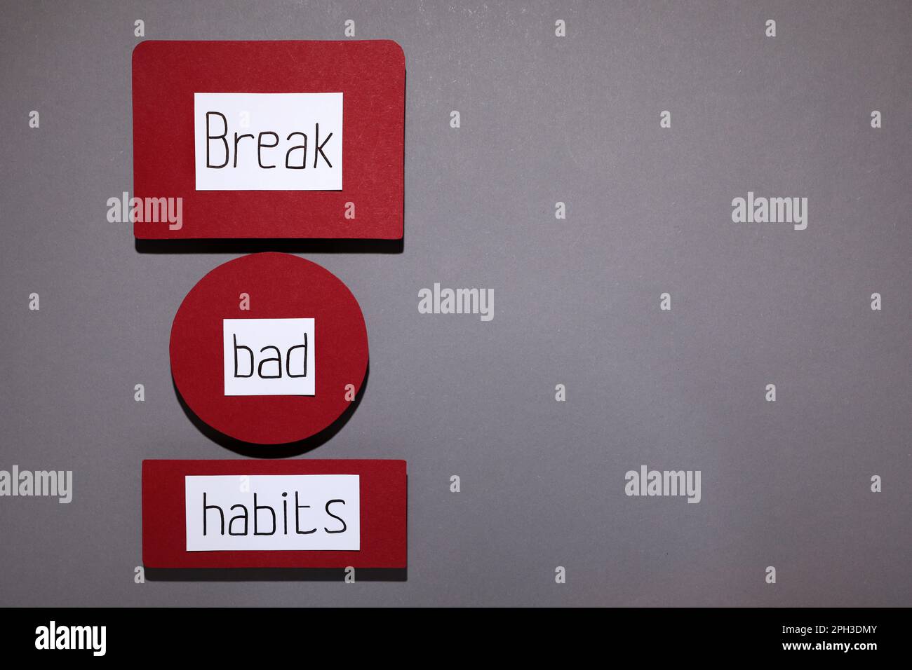 Flat lay composition with phrase Break Bad Habits on grey background ...