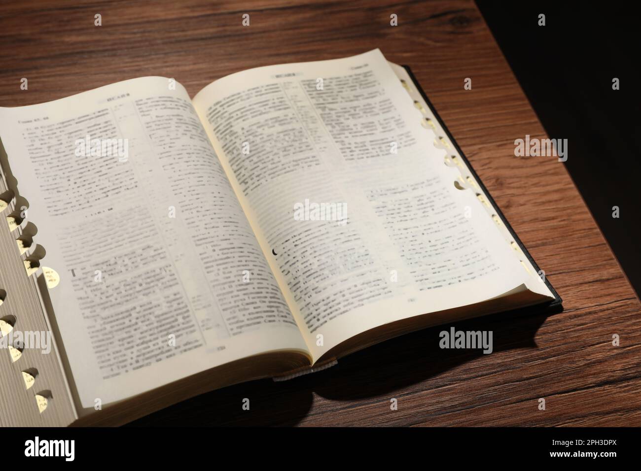 Open Bible on wooden table. Christian religious book Stock Photo - Alamy