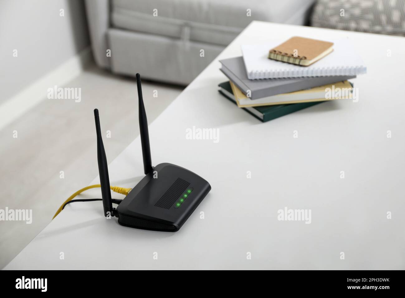 Modern Wi-Fi router on white table in room. Space for text Stock Photo ...