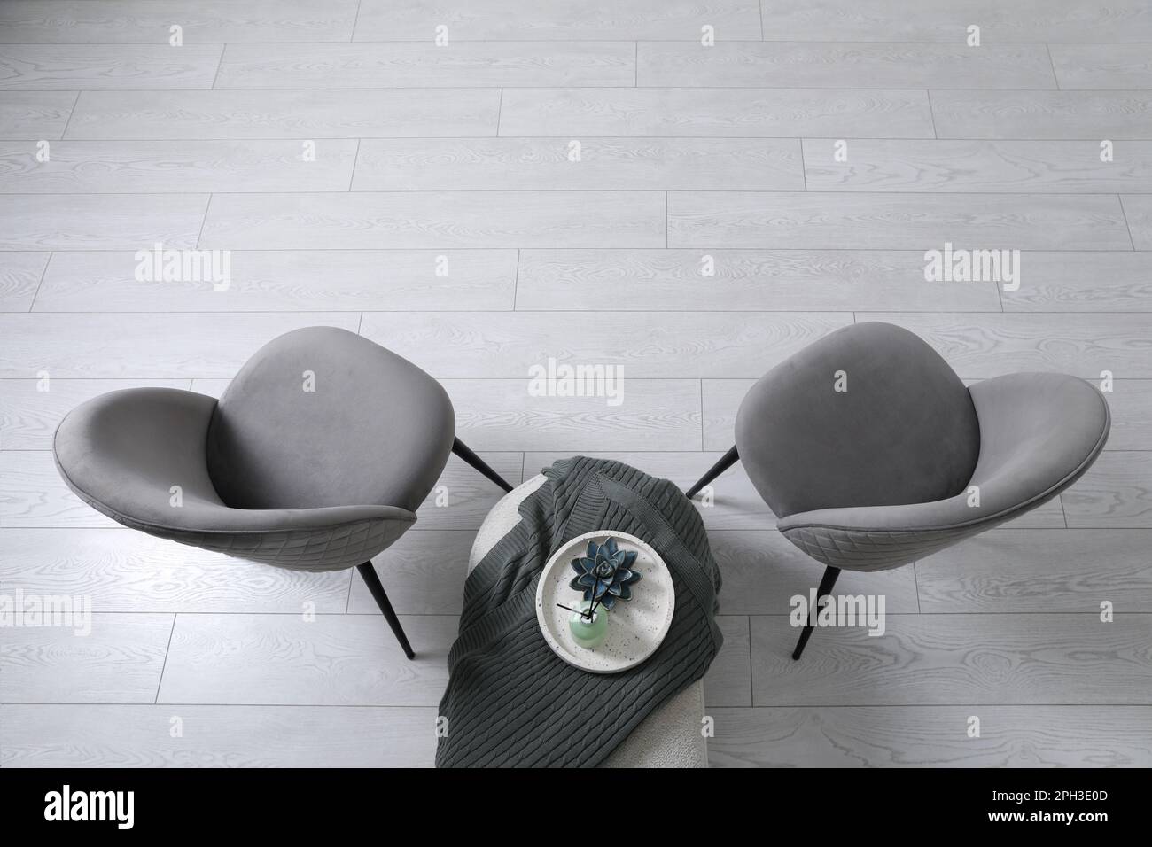 Stylish grey chairs and pouf with decor in room, top view. Interior ...