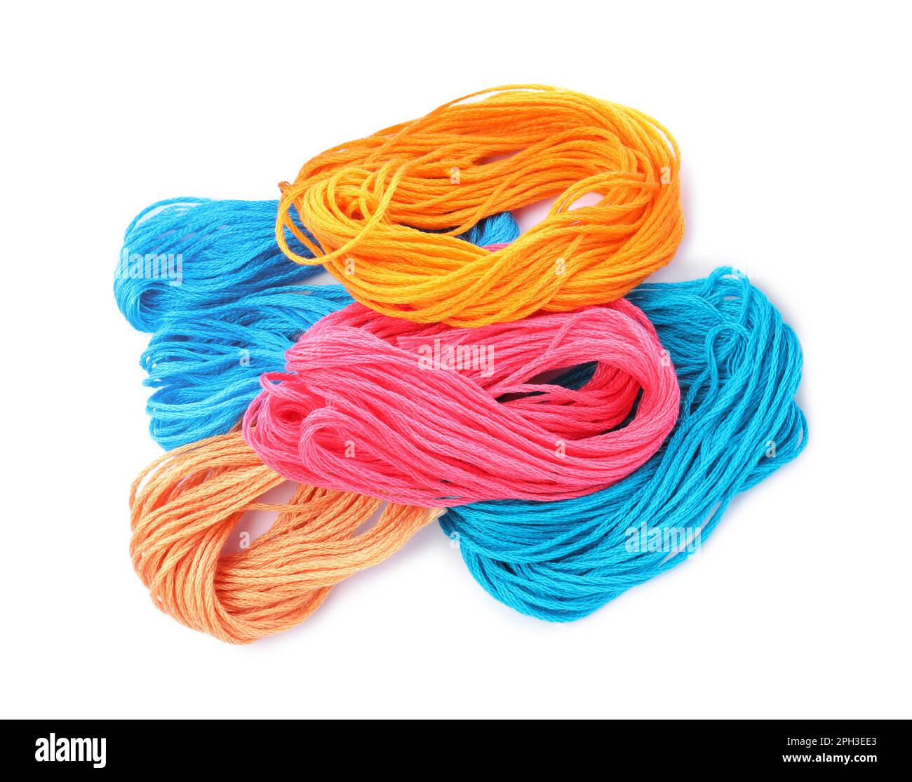 Different colorful embroidery threads on white background, top view ...