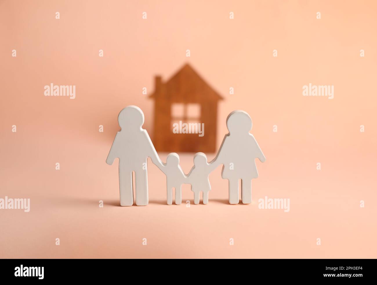 Figures of family and house on pink background Stock Photo - Alamy