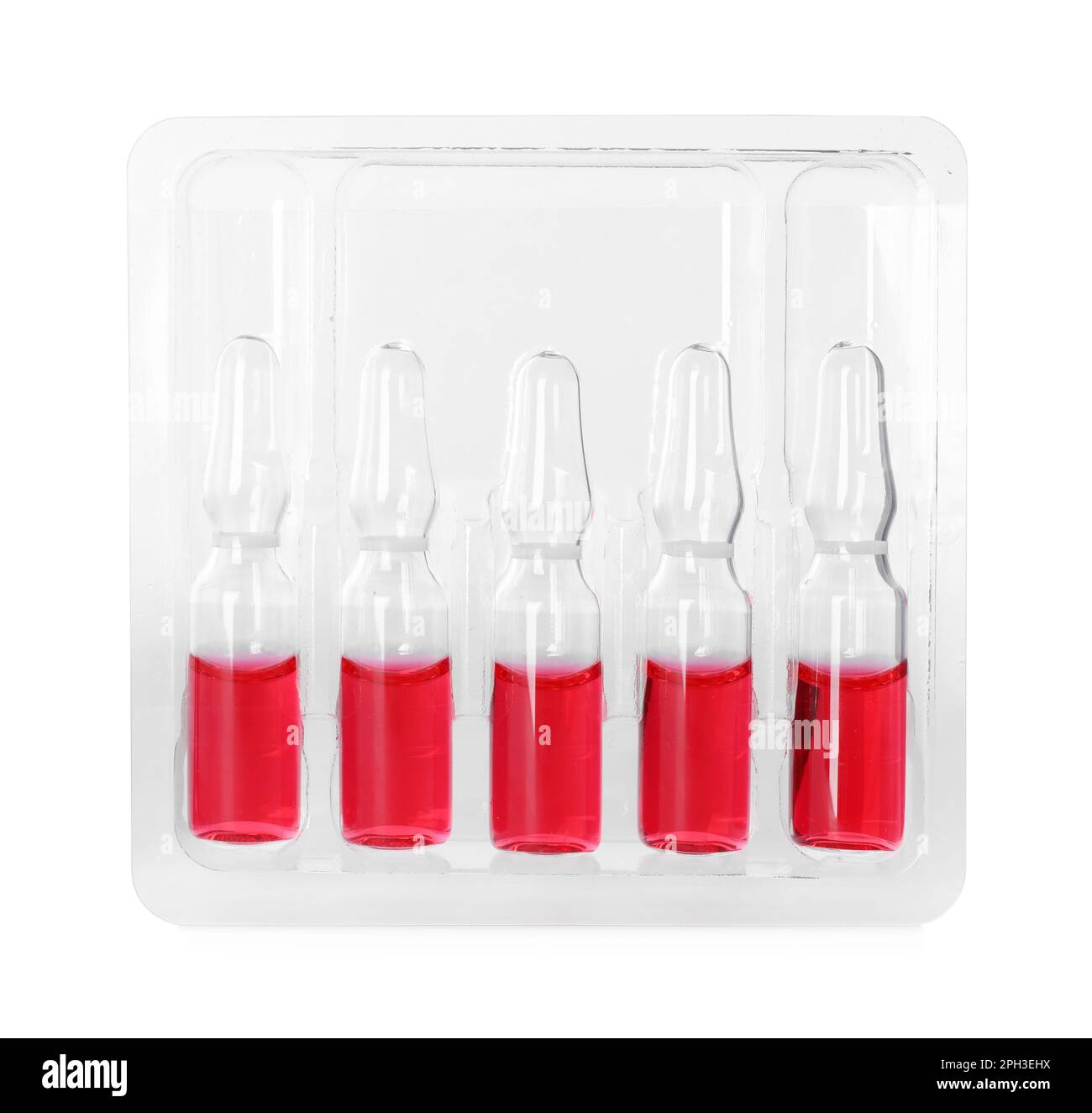 Glass ampoules with pharmaceutical product in tray on white background ...