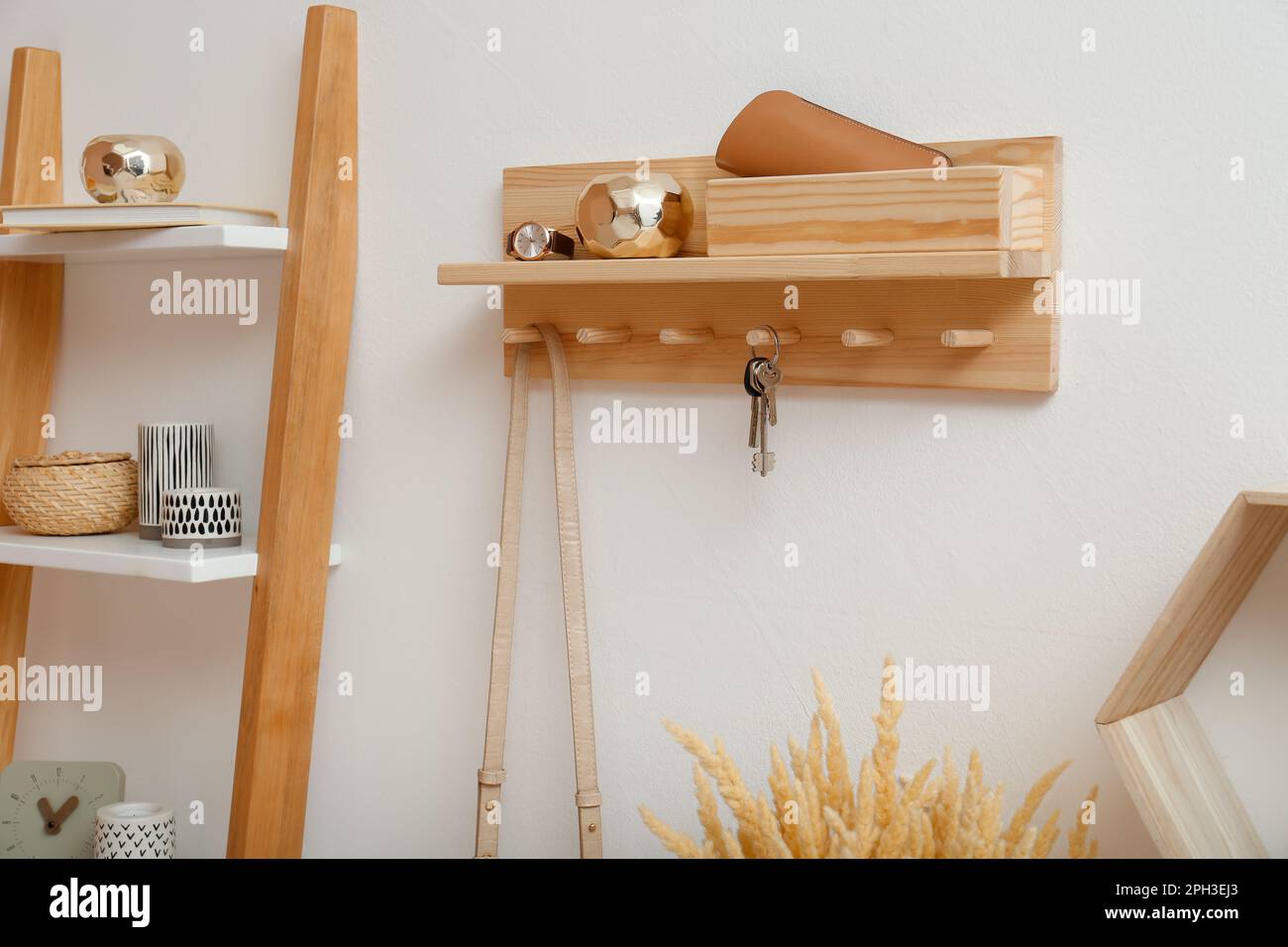 Stylish hanger for keys on white wall in hallway Stock Photo - Alamy