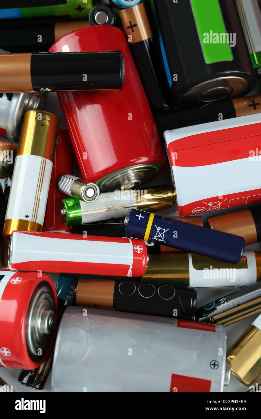 Many batteries of different types as background, above view Stock Photo ...