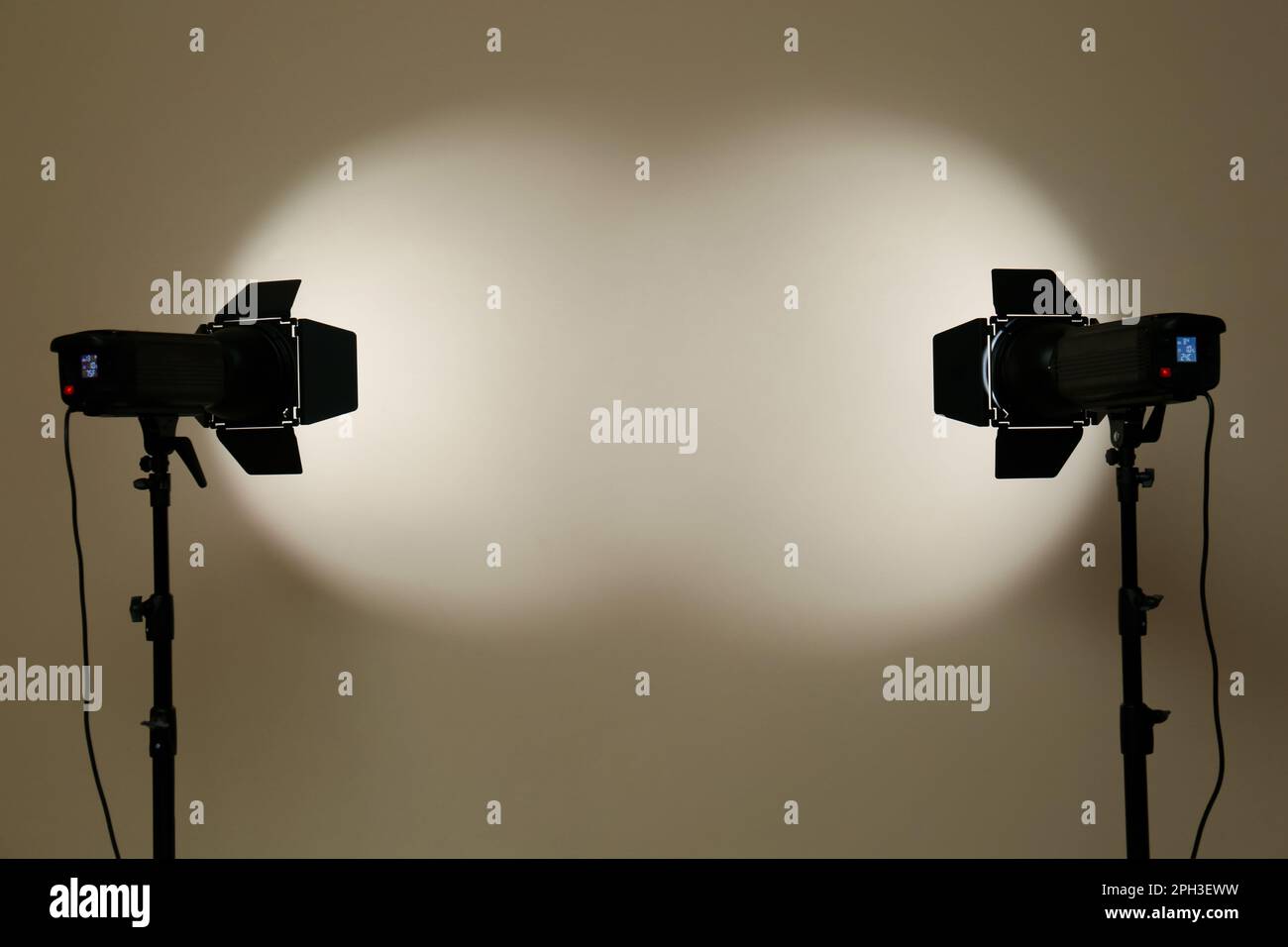 Modern spotlights against beige background, space for text Stock Photo ...
