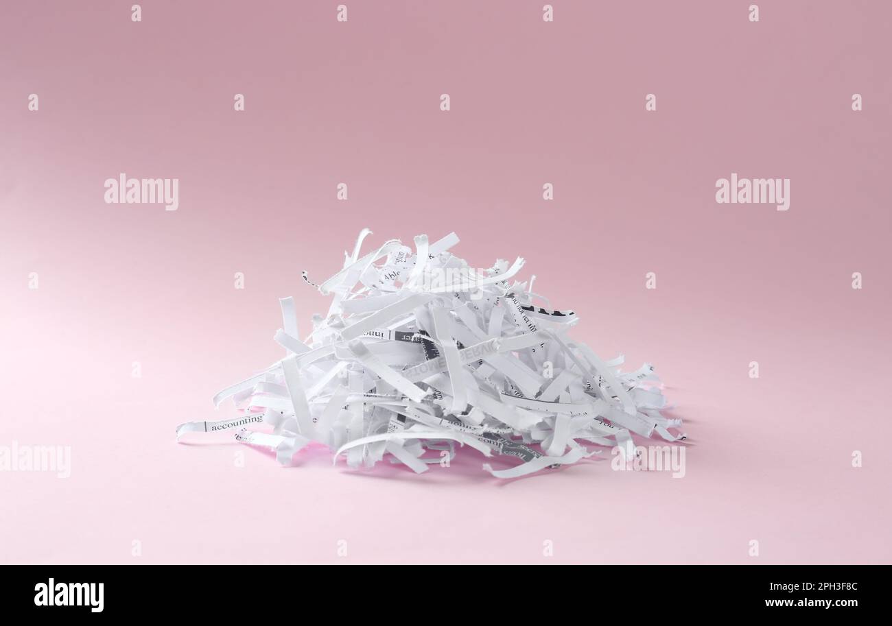 Heap of shredded paper strips on violet background Stock Photo - Alamy