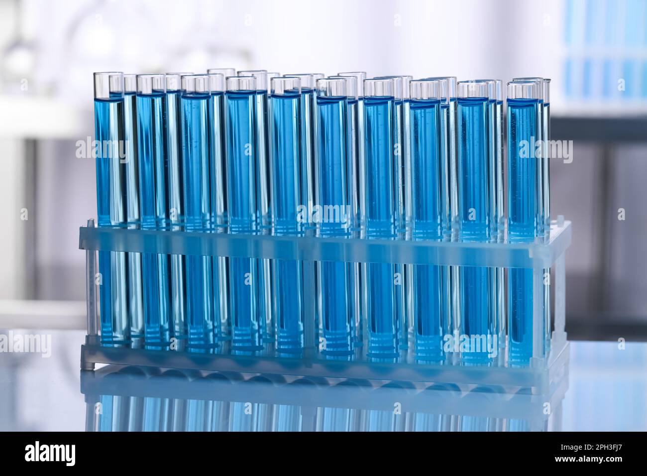 Test tubes with reagents on table in laboratory Stock Photo - Alamy