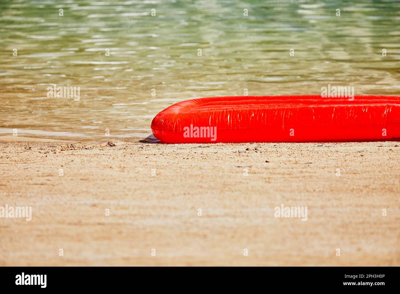 A Red Inflatable Float at Water's Edge Stock Photo - Alamy